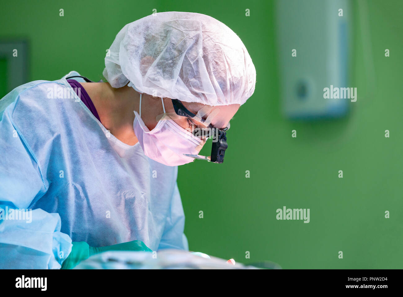 female surgeon doctor wearing protective mask and hat during the ...