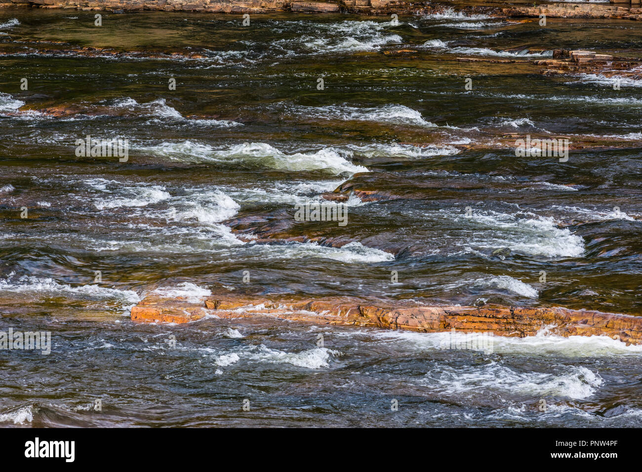 Water flowing over rocks forming little rapids and waterfalls Stock ...