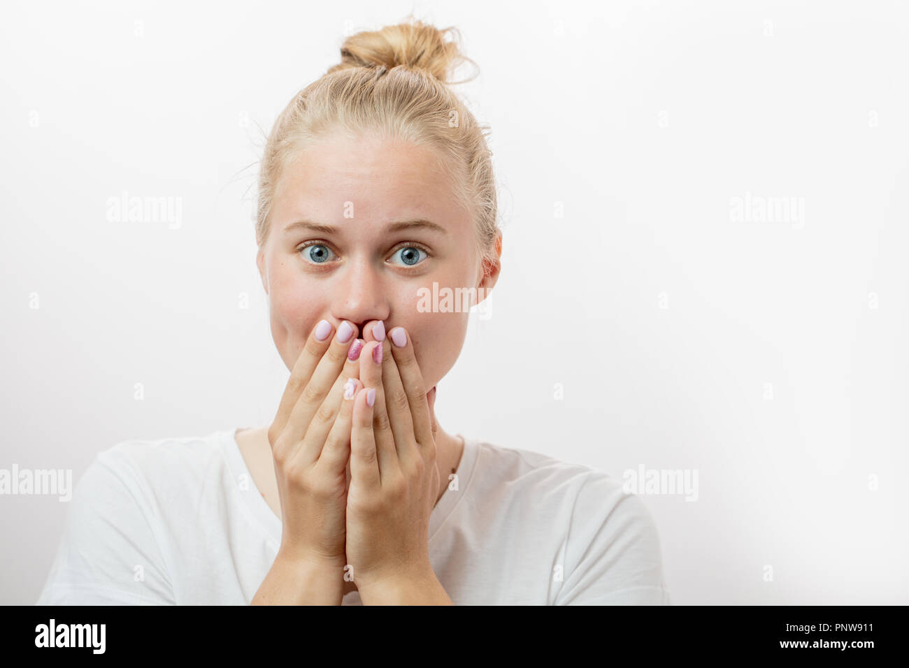 Young female looks with terrified expression, isolated over white ...