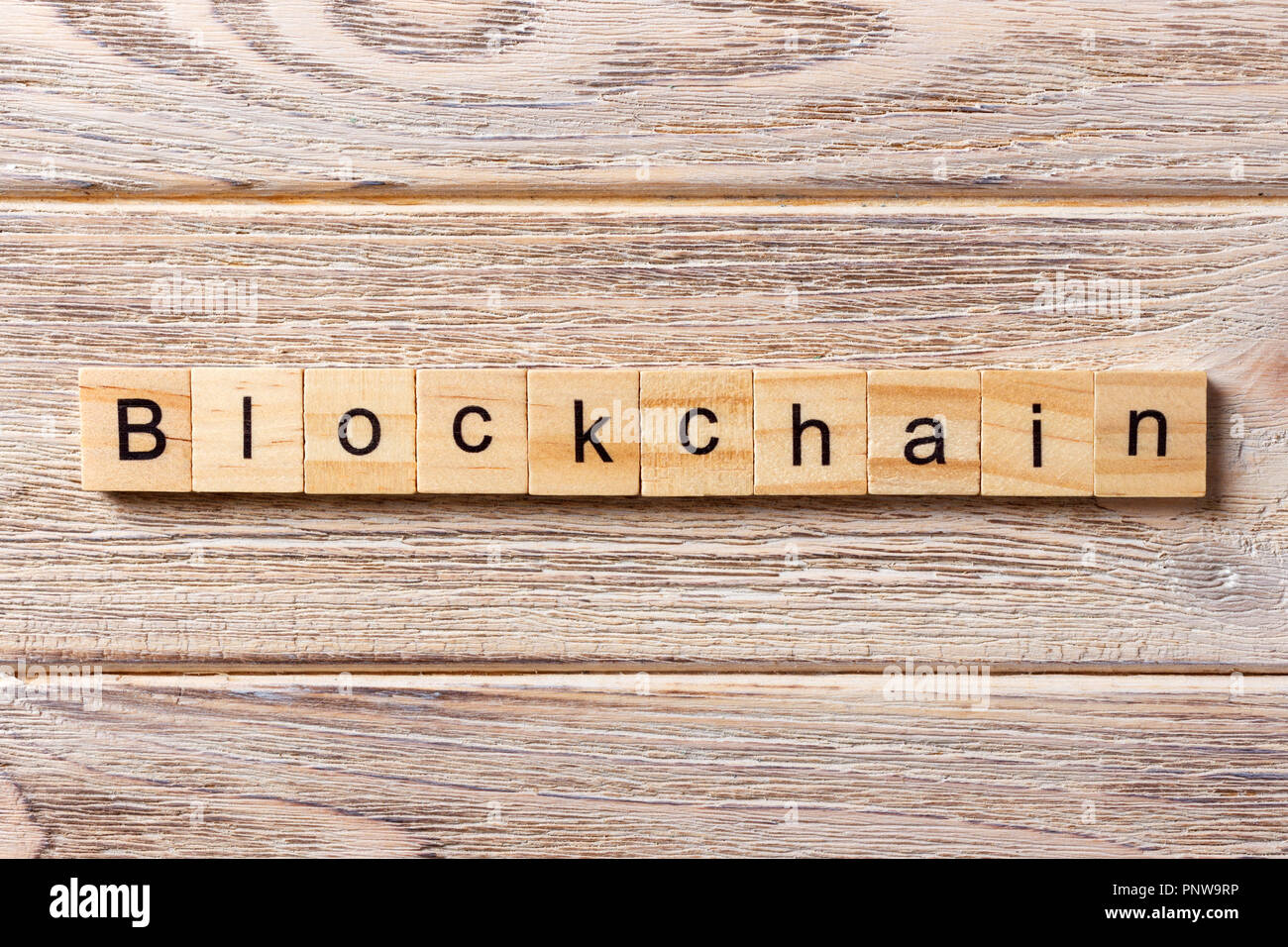 BLOCKCHAIN word written on wood block. BLOCKCHAIN text on table ...
