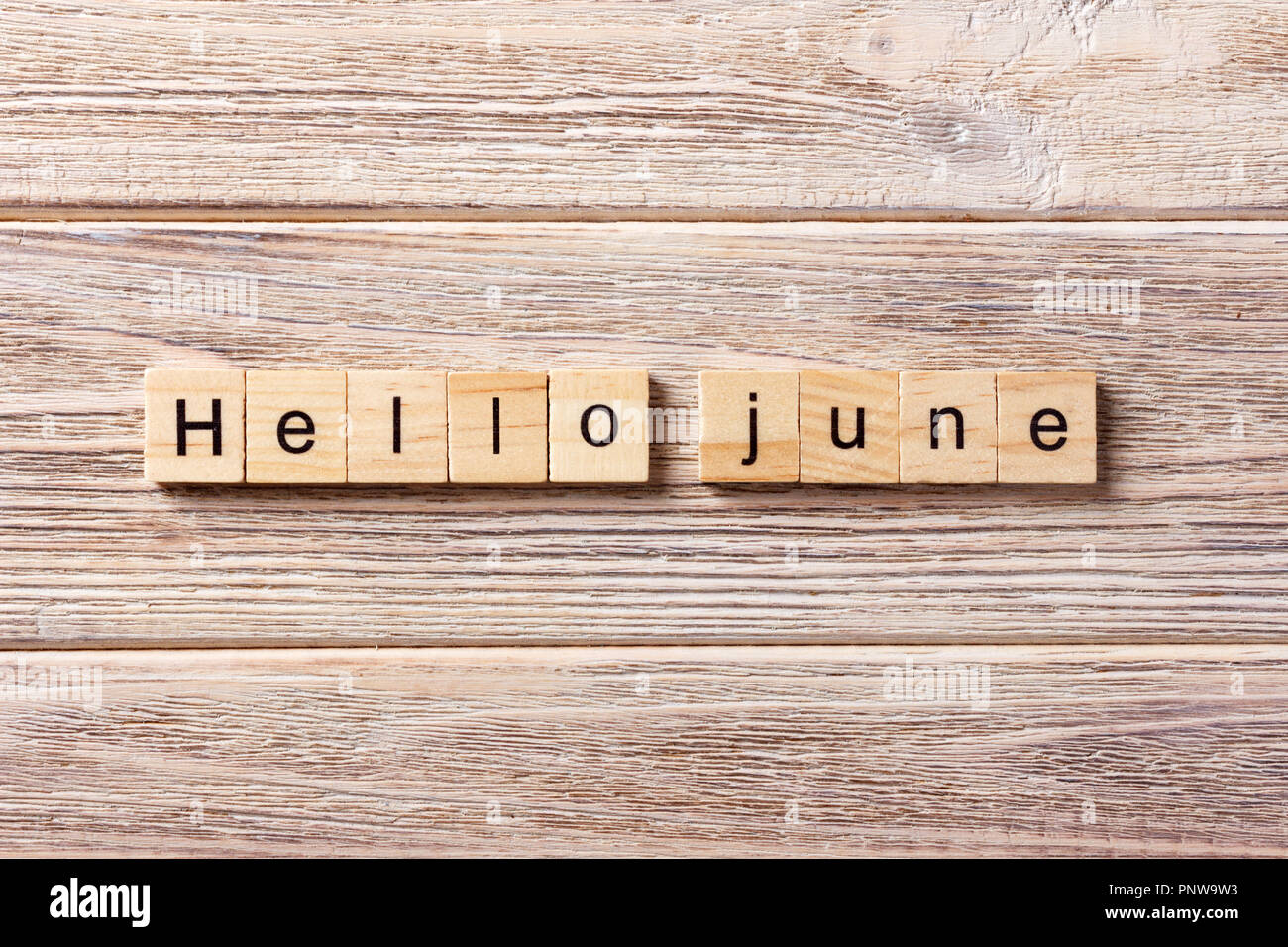 Hello June word written on wood block. Hello June text on table ...