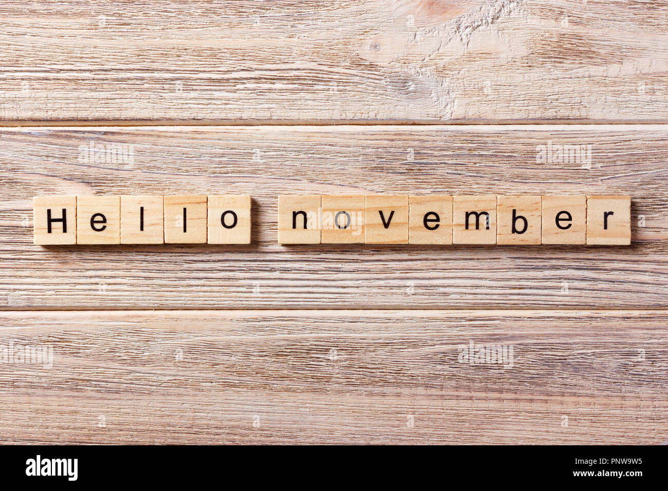 Hello November word written on wood block. Hello November text on table ...
