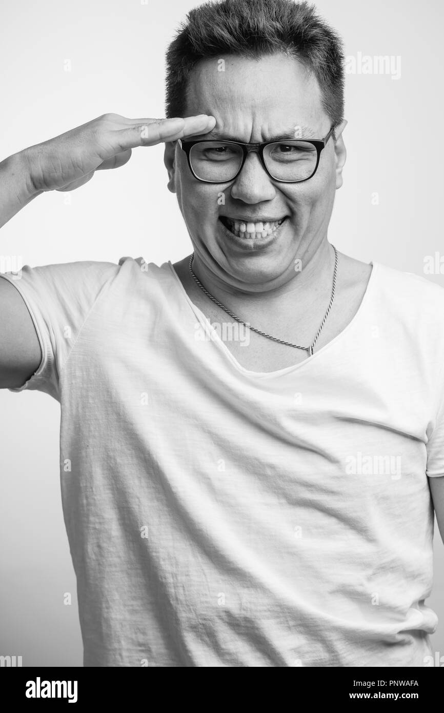 Asian man in salute pose, ready to fulfill the order Stock Photo - Alamy