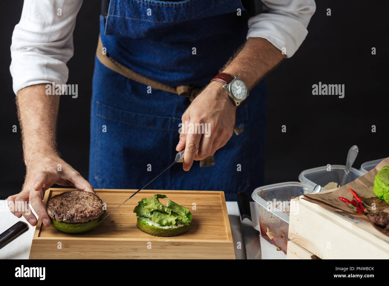 Male Chef prepares yummy fresh burger, close up Stock Photo - Alamy