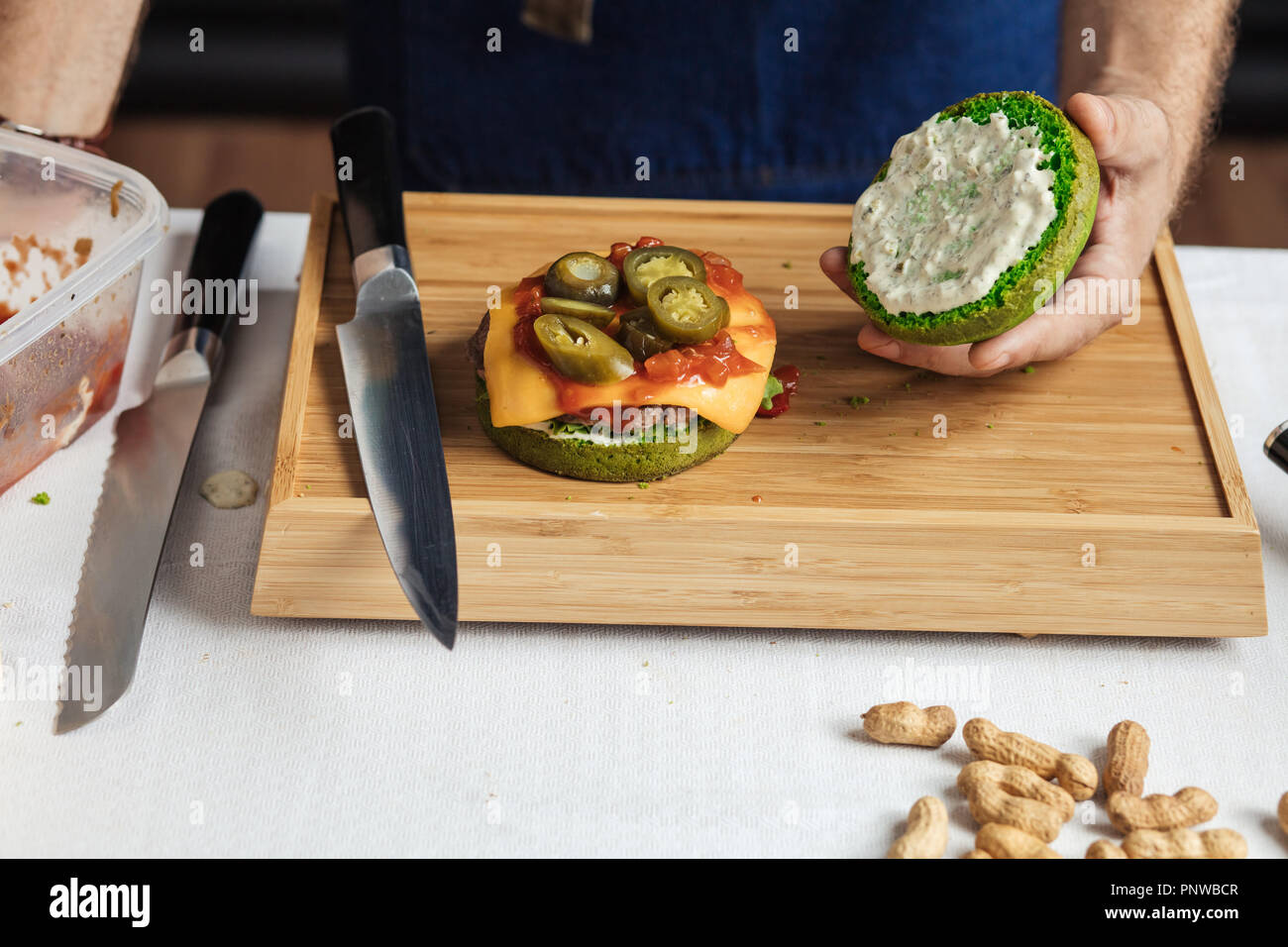 Male Chef prepares yummy fresh burger, close up Stock Photo - Alamy