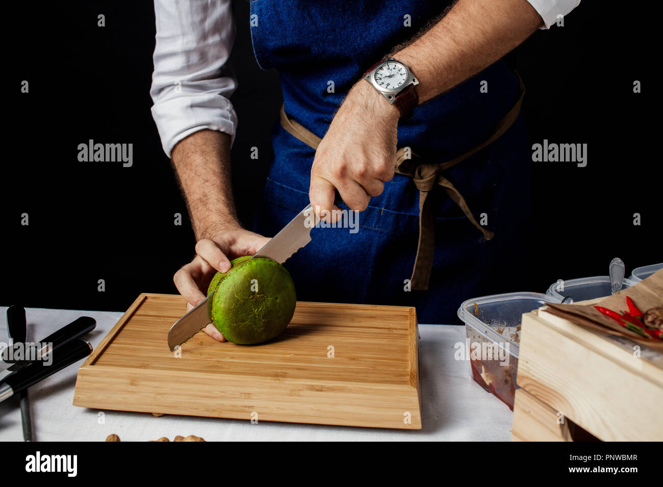 Process of cooking burgers. Master Cook cutting green spinach bun ...