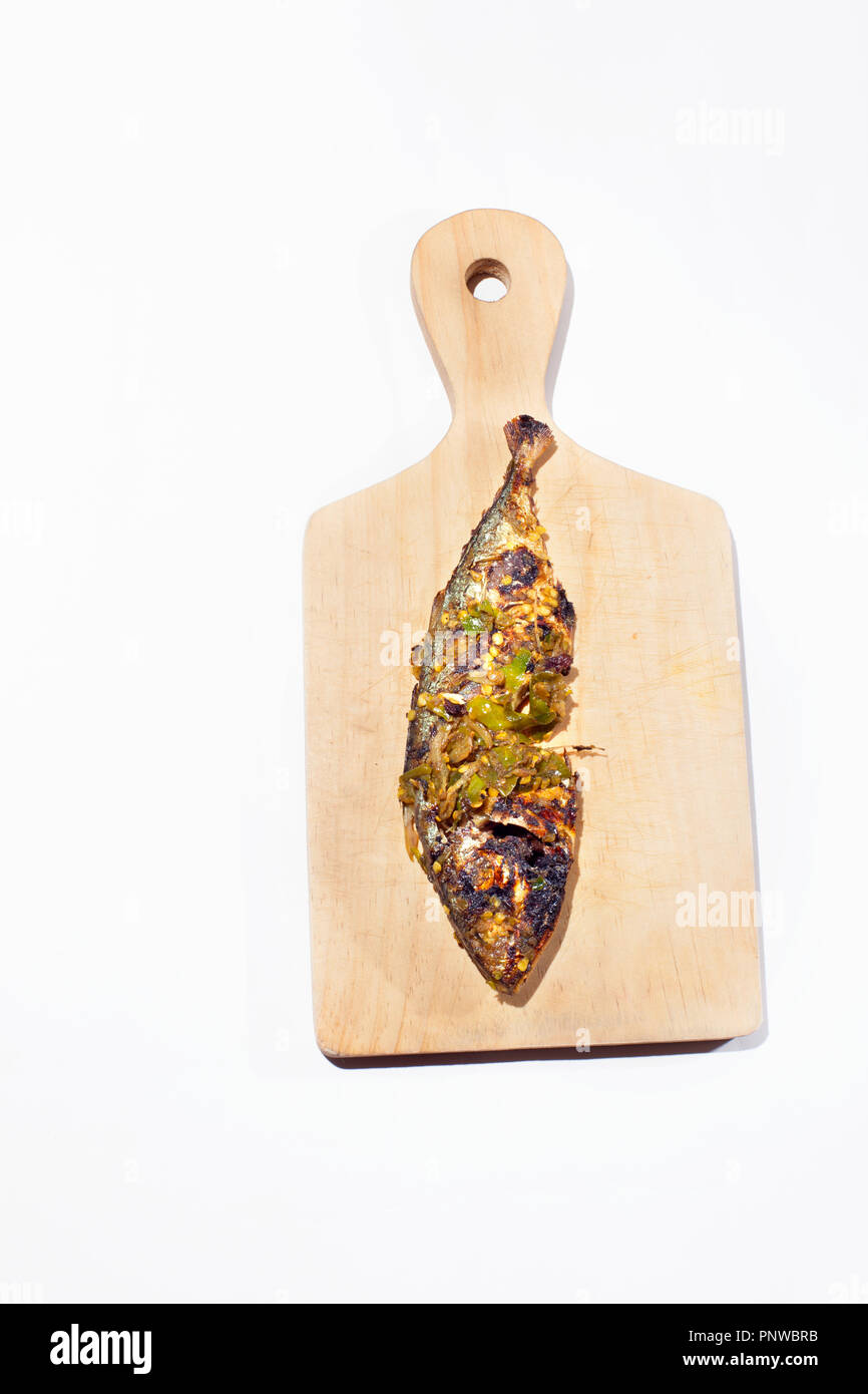 Grilled fish on a cutting board, isolated on white background. Food ...