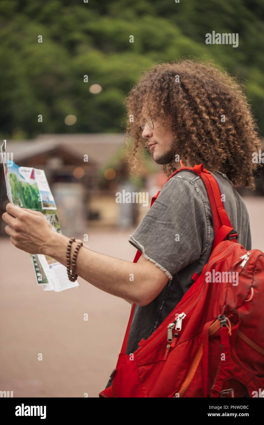 tourist with route maps looking for a way in city. search landmarks ...