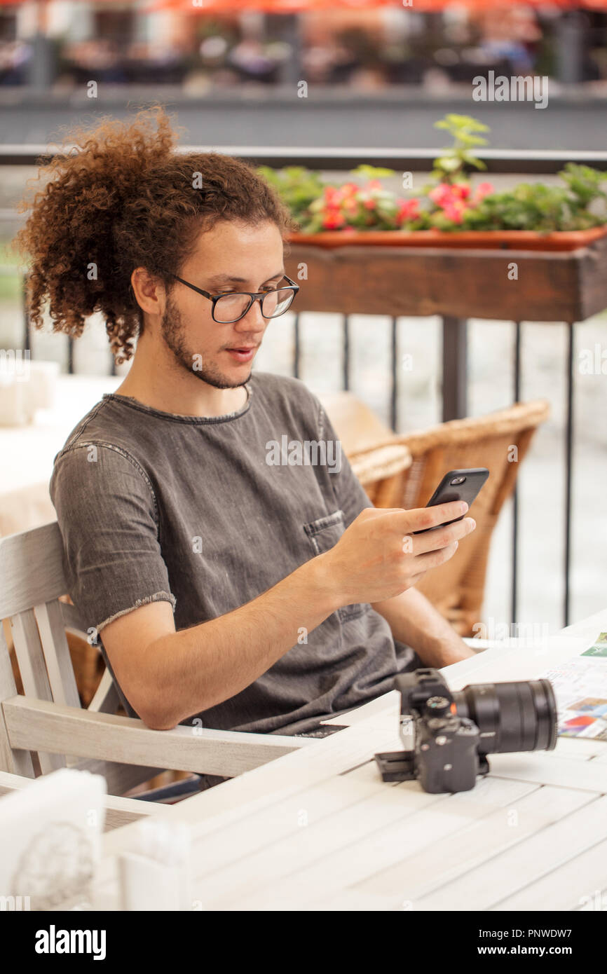guy traveler planning trip for vacation with smartphone and map while ...