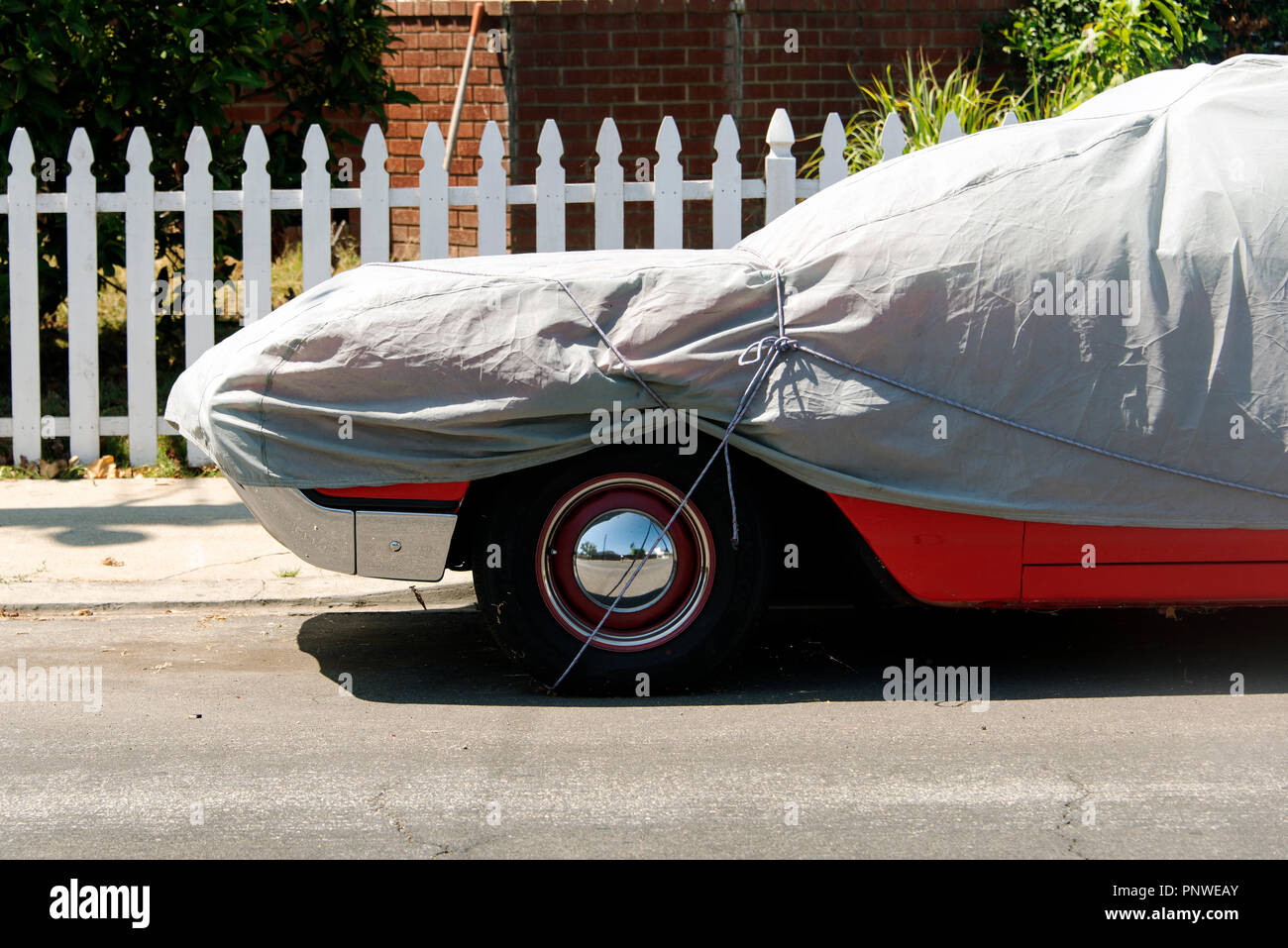 A view of a classic vintage car with a cover in the street in Venice ...
