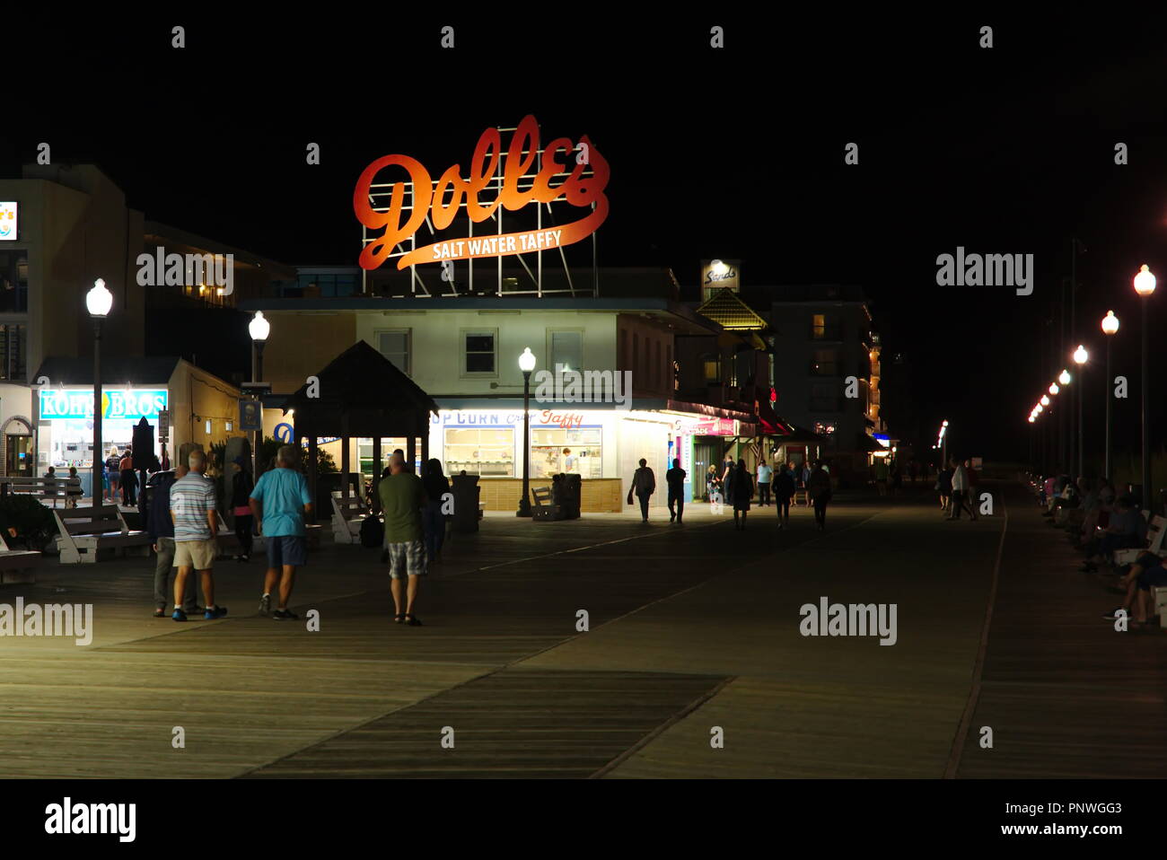 Tourists stroll the Rehoboth Beach (Delaware) boardwalk at night Stock ...