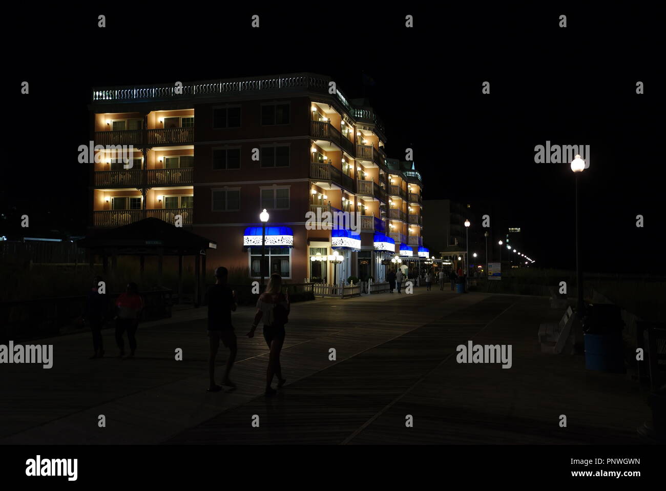 Tourists stroll the Rehoboth Beach (Delaware) boardwalk at night Stock ...