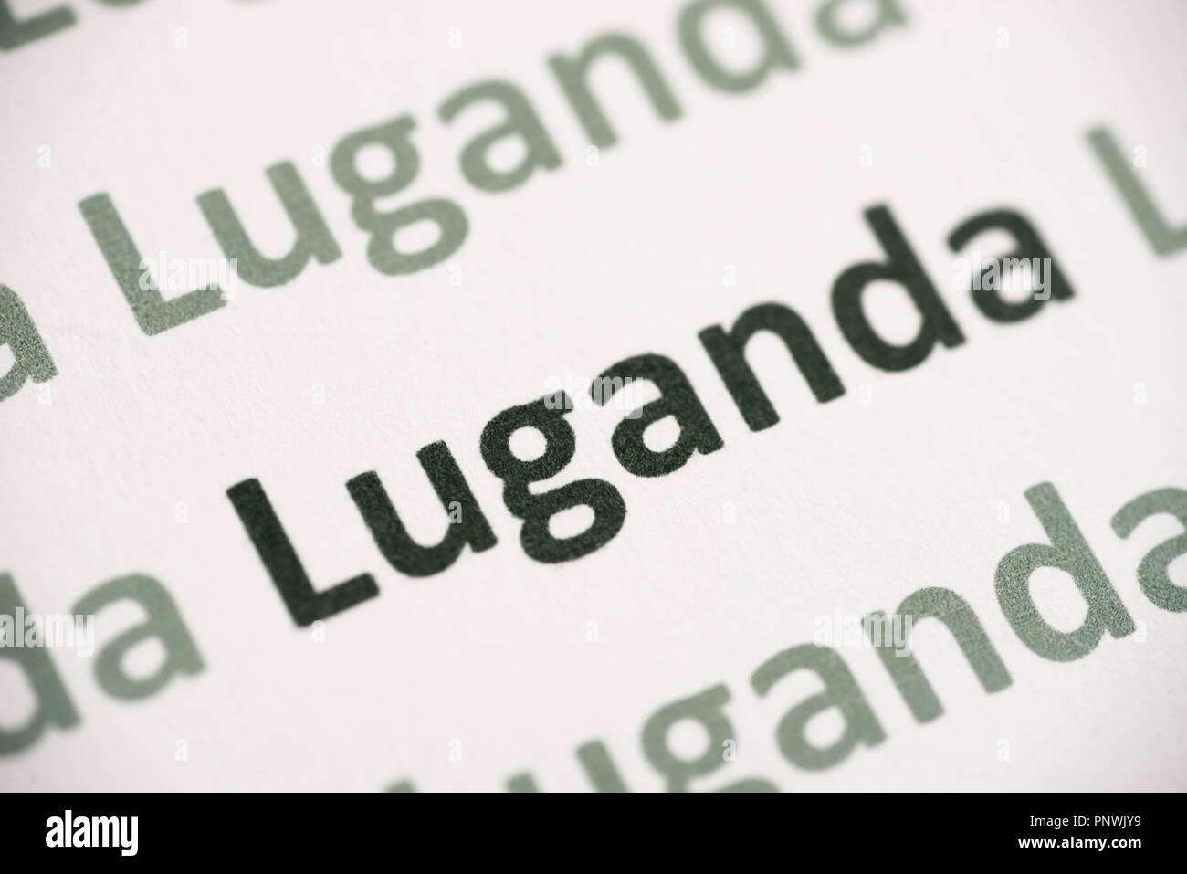 word Luganda language printed on white paper macro Stock Photo - Alamy