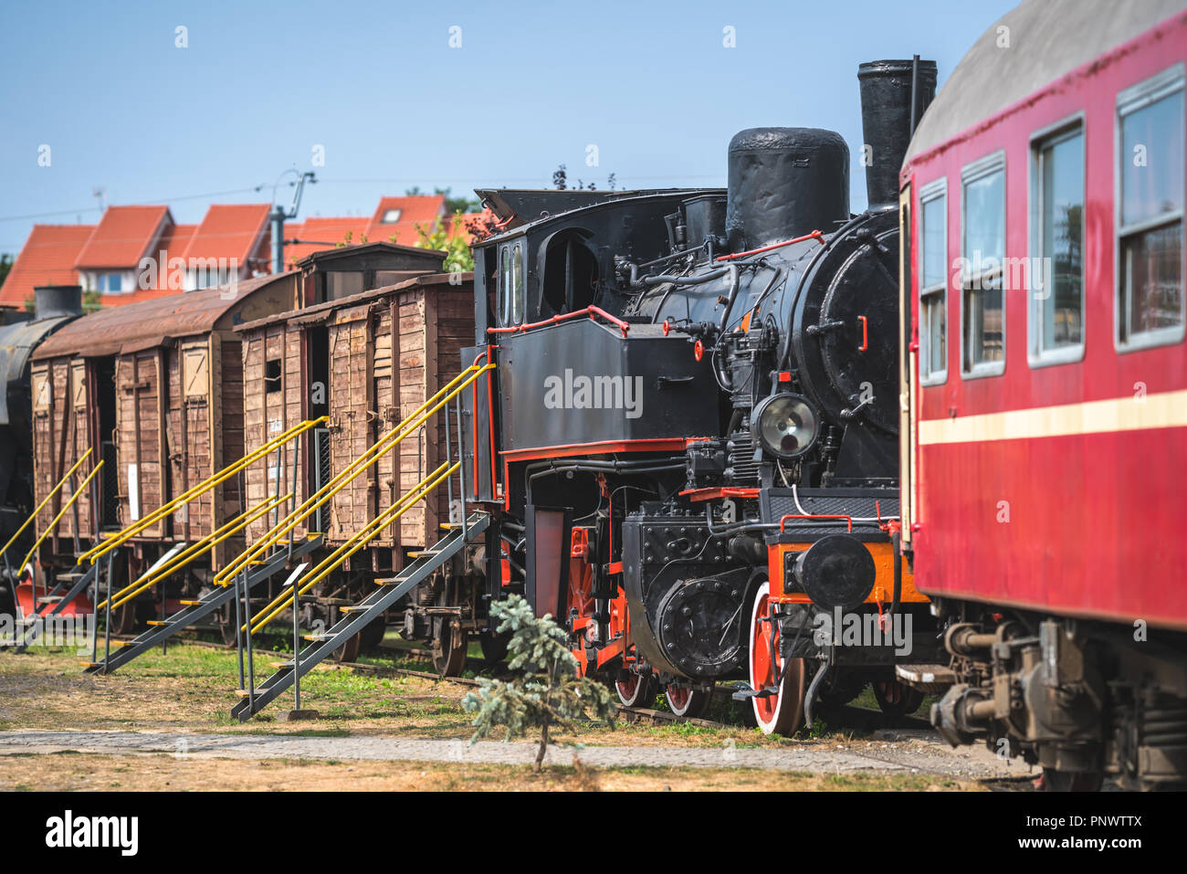 An old disused retro steam train locomotive and passenger carriages on ...