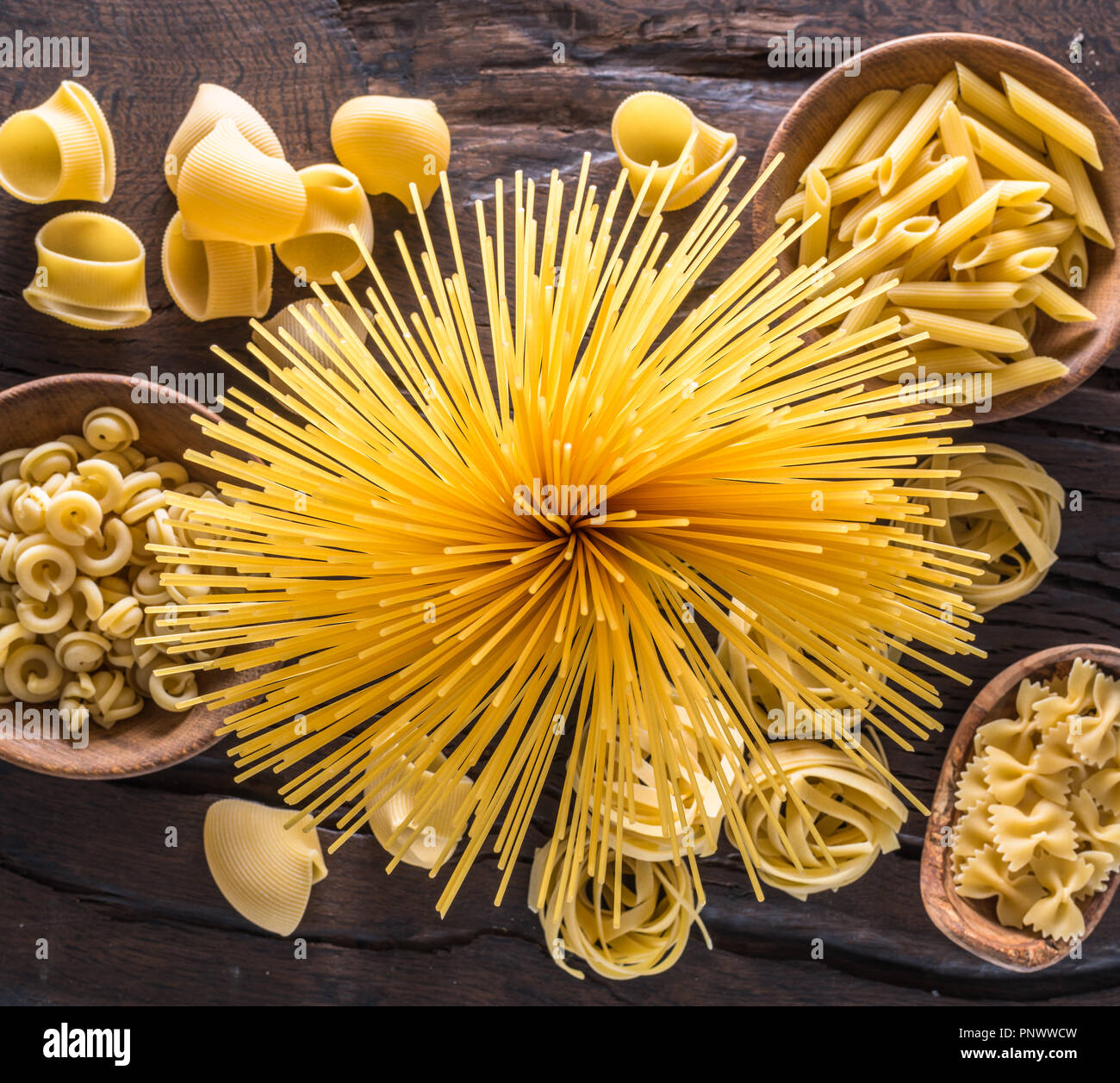 Different pasta types on the wooden table. Top view Stock Photo - Alamy