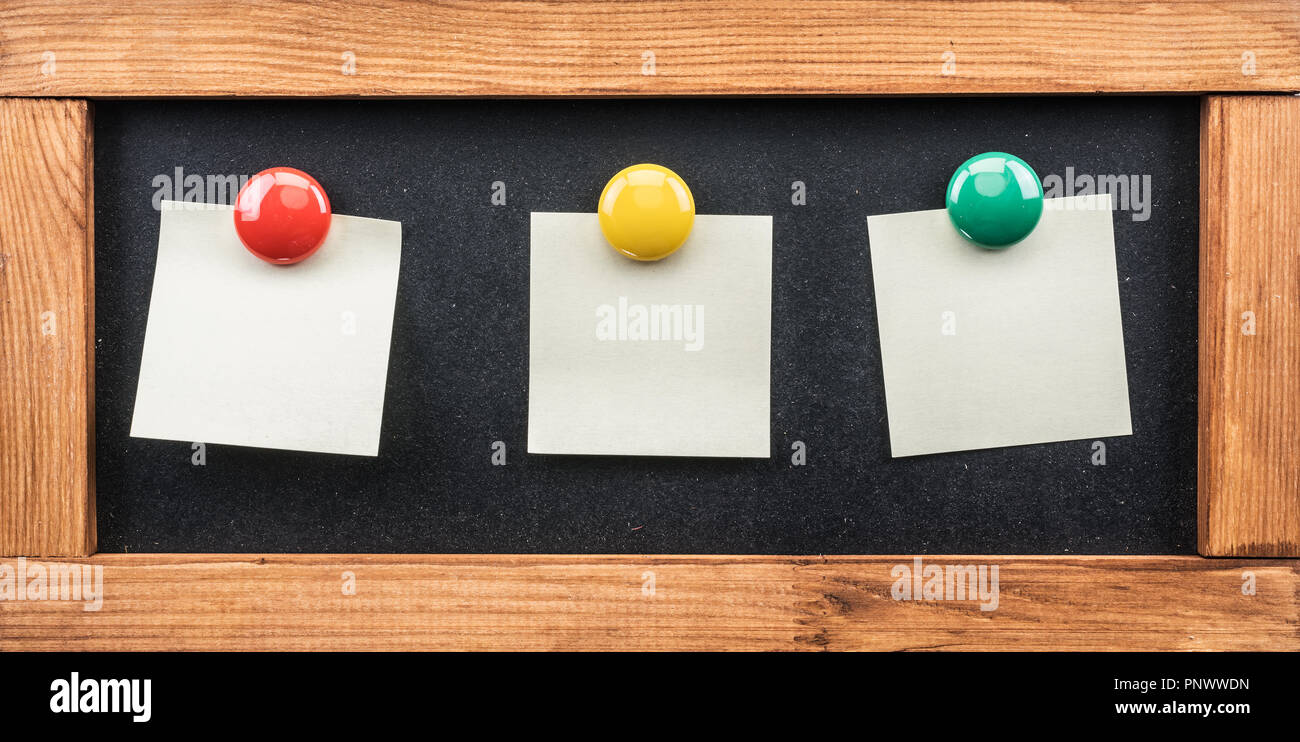 Blackboard and post-it notes stuck with colorful magnets Stock Photo ...