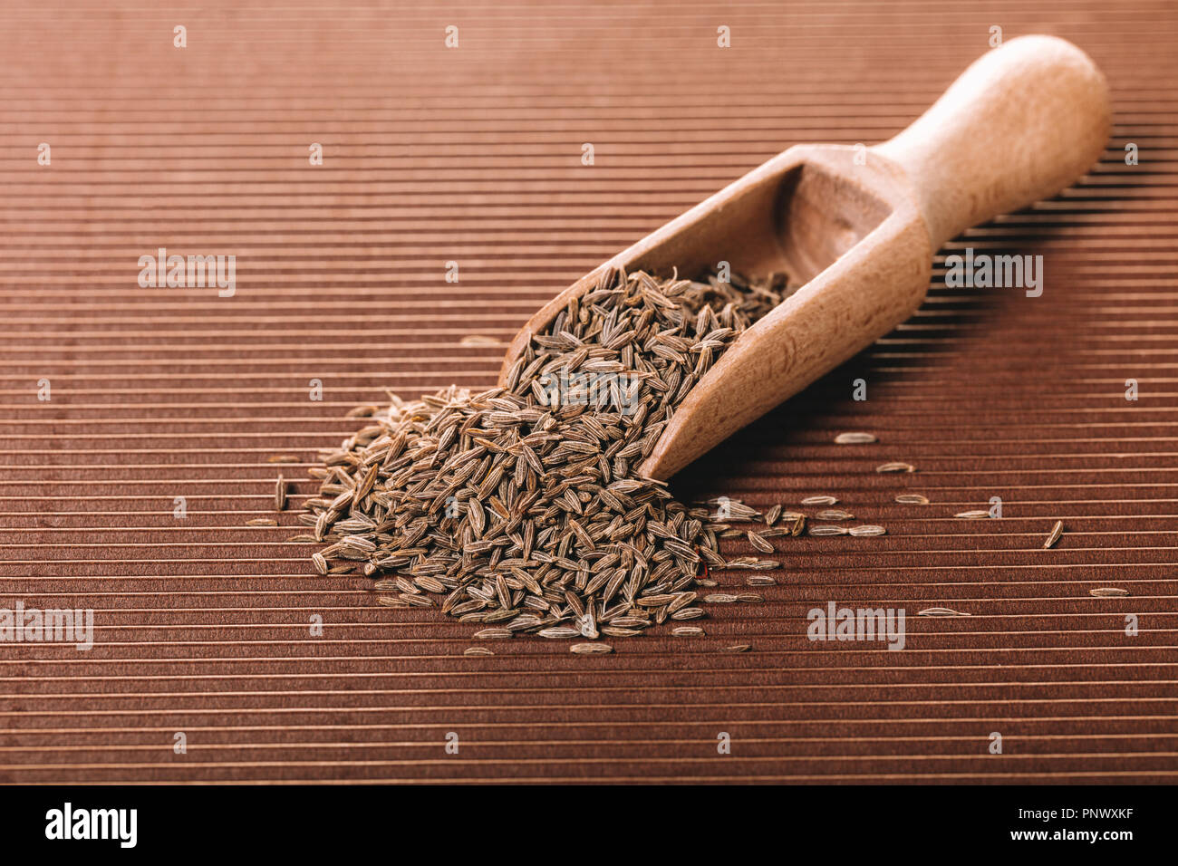 dry spices cumin closeup on a brown background Stock Photo - Alamy