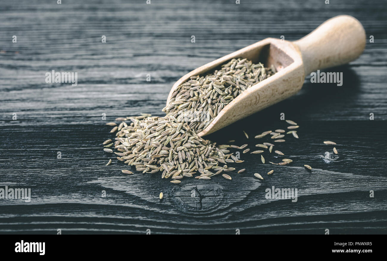 dry spices cumin on a black wooden background Stock Photo - Alamy
