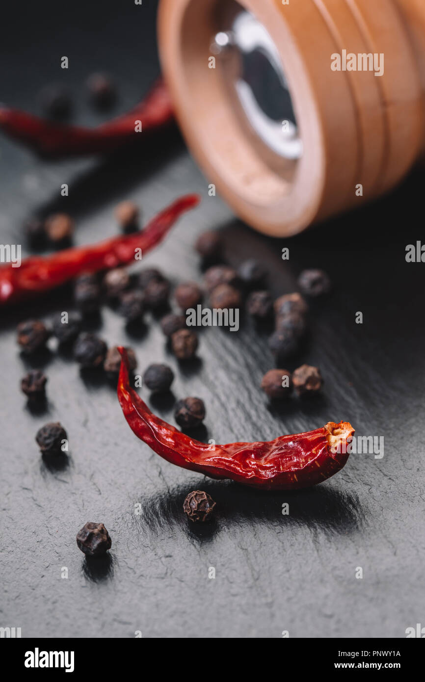 pepper with spices close-up on a black background Stock Photo - Alamy