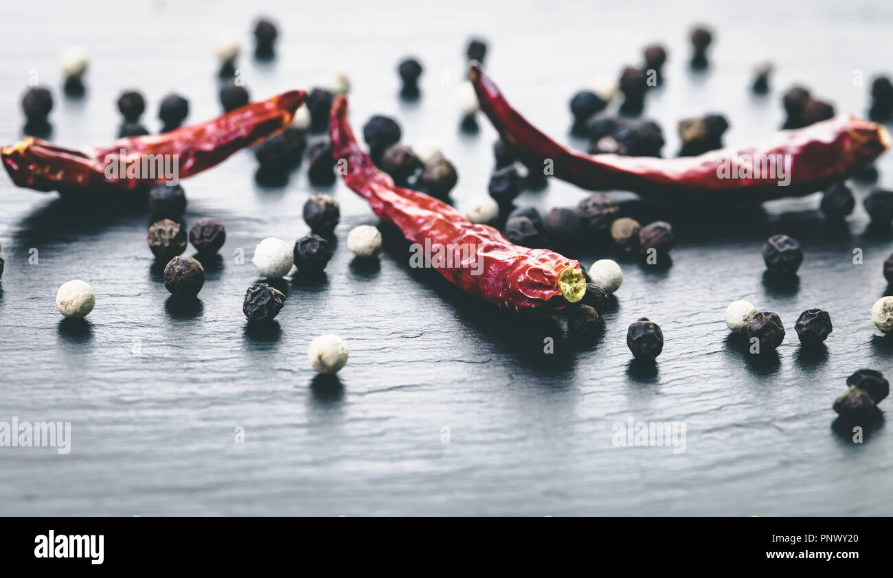 food background dry spicy and fragrant peppers close-up on black Stock ...