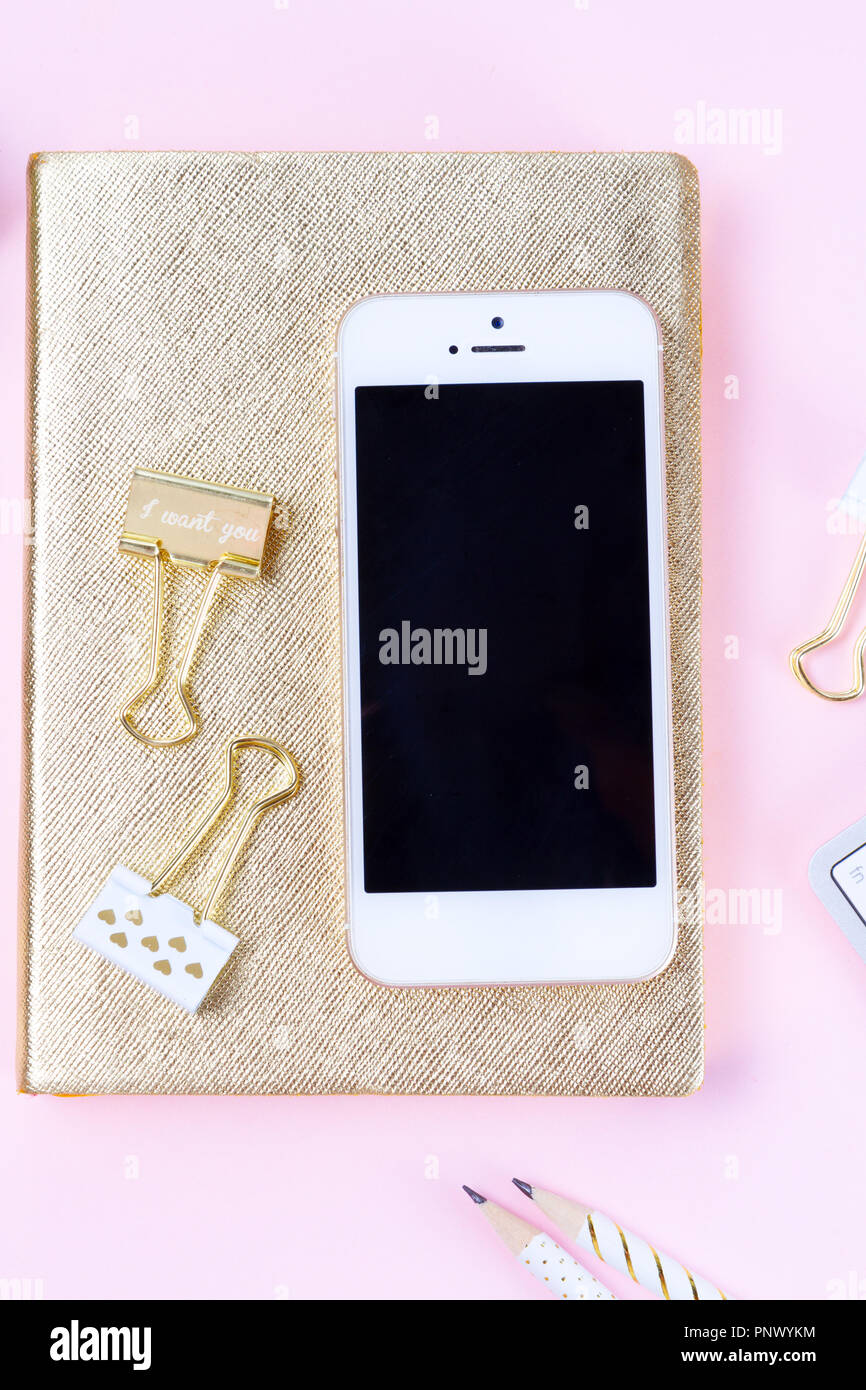 Home office desk with modern white phone on pink background Stock Photo ...