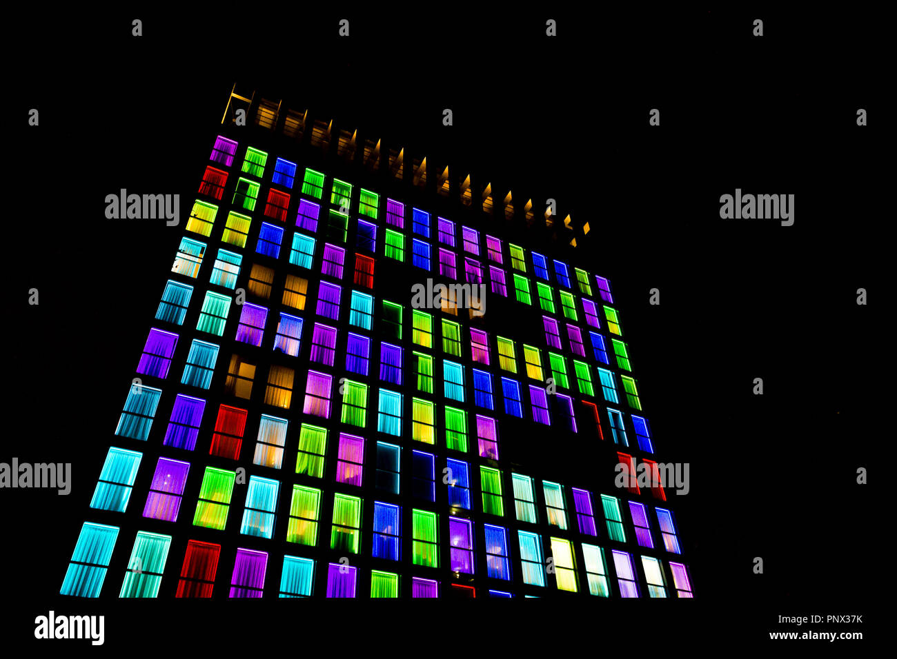 Colored windows texture. Windows illuminated by neon lights background ...