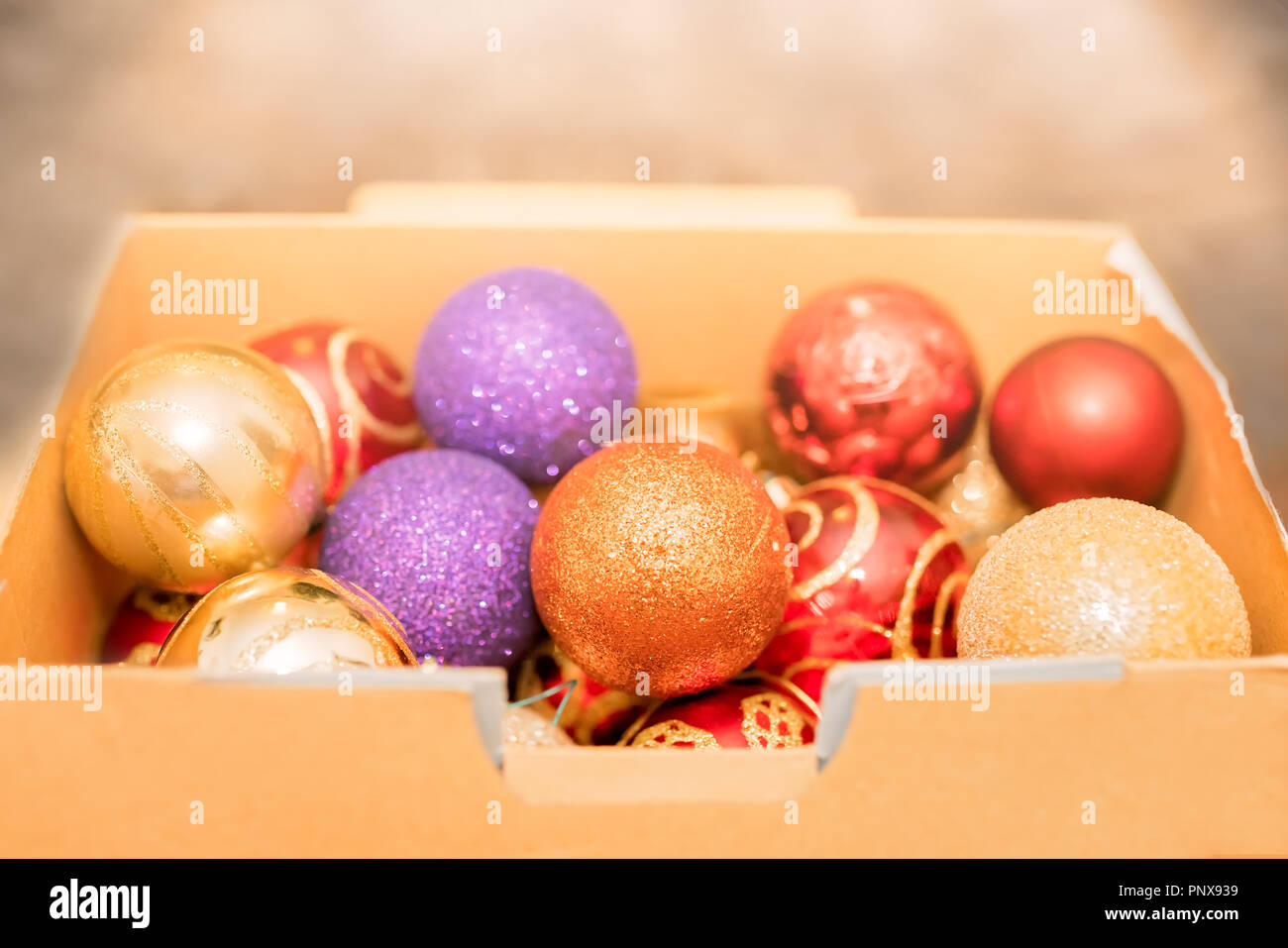 Close up of the colorful Christmas decorations stored in a cardboard ...