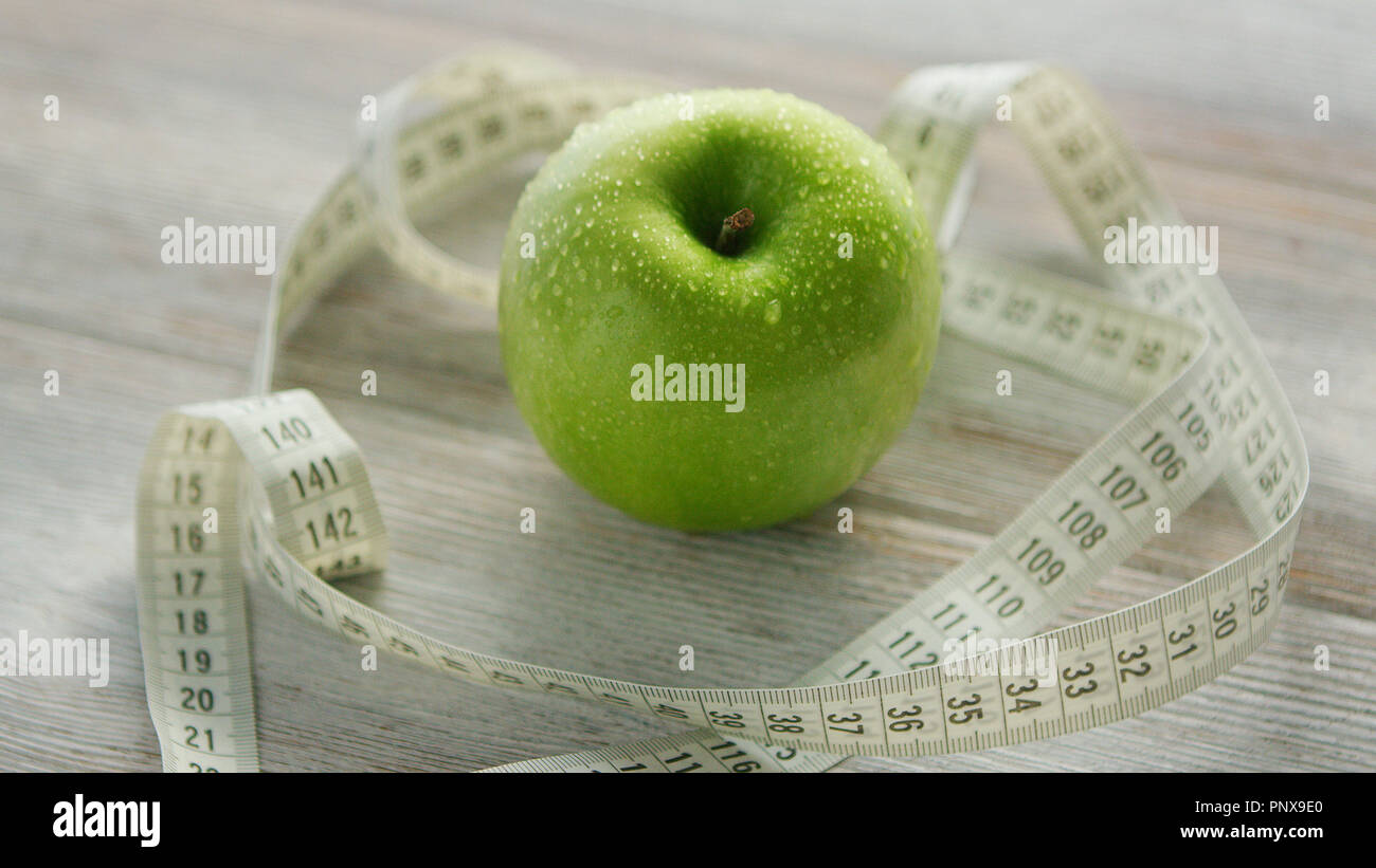 Green apple and tape measure Stock Photo - Alamy