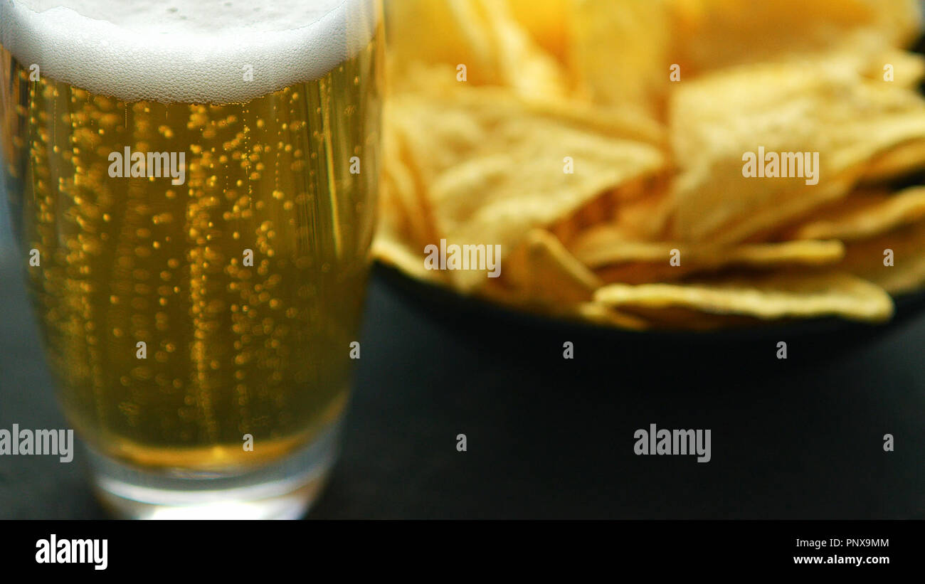 Glass of beer and nacho chips Stock Photo - Alamy