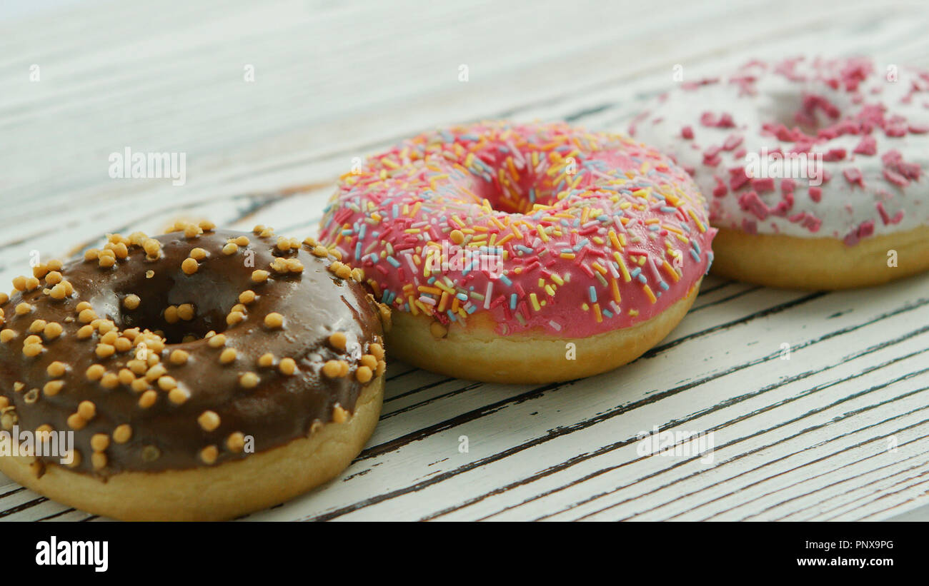 Row of sweet glazed doughnuts Stock Photo - Alamy
