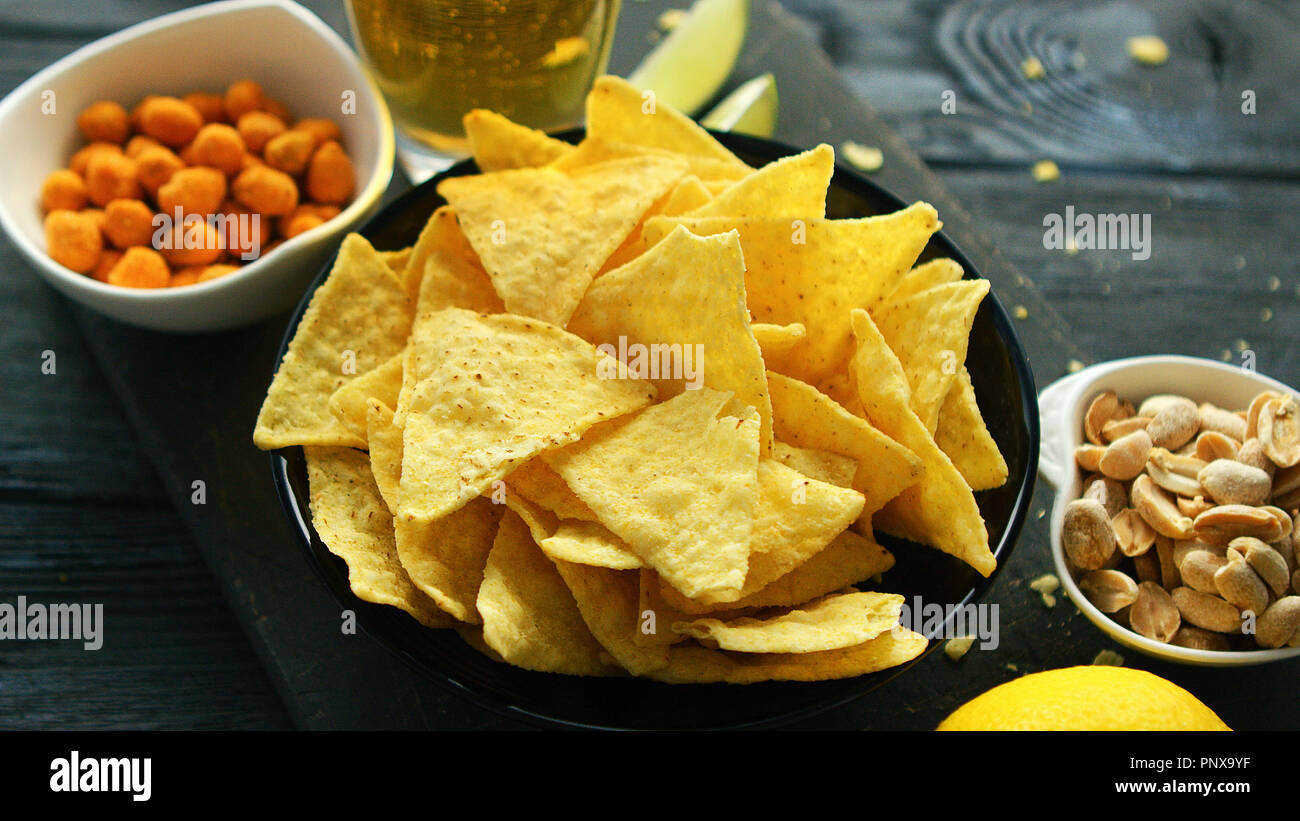 Plate of corn chips with nuts Stock Photo - Alamy