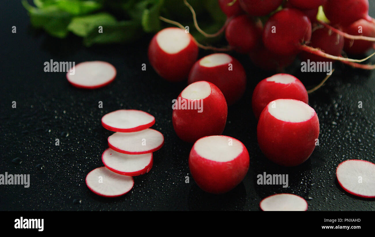 Small red radish in slices Stock Photo - Alamy