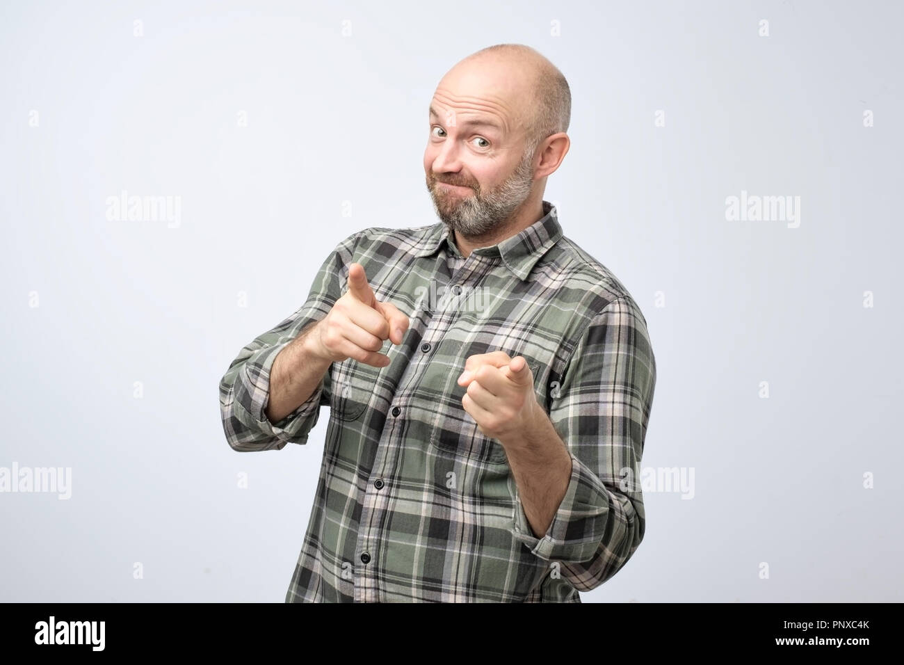 Hey, you are awesome. Portrait of happy bearded man pointing at you ...