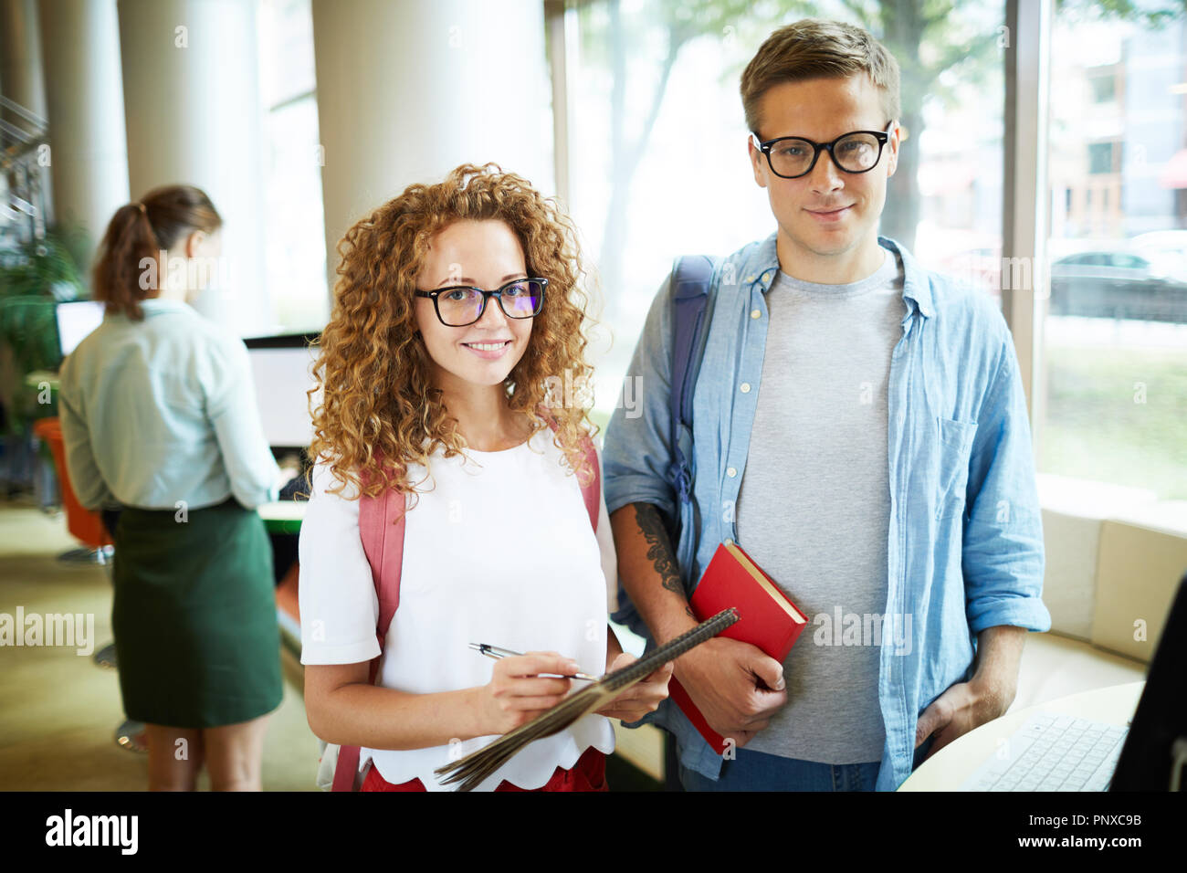 Two young diligent students in casualwear working in computer class ...