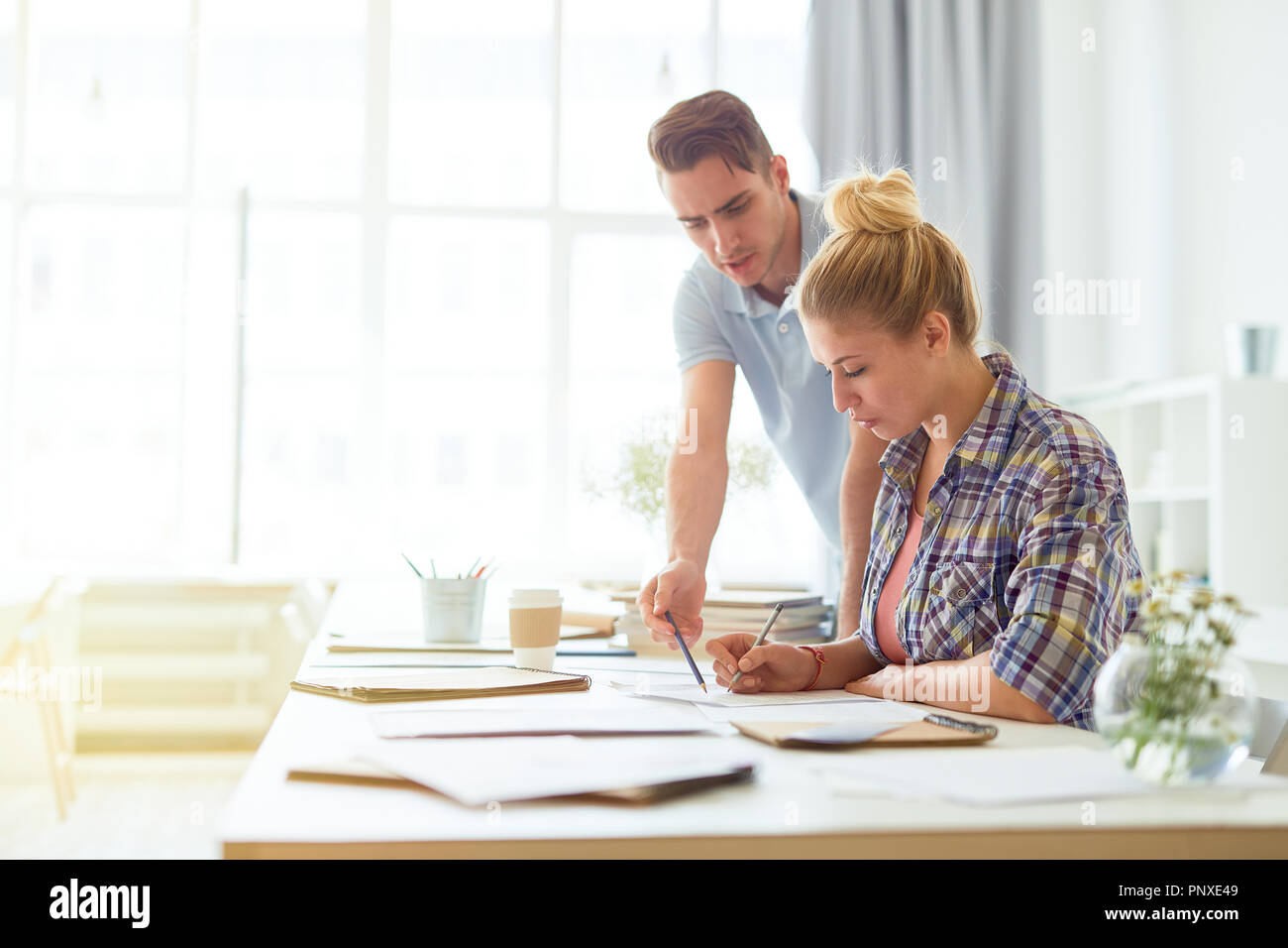 Confident businessman explaining his colleague difficult point while ...