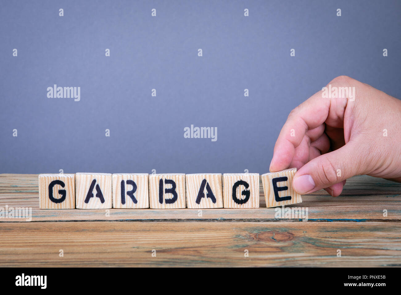garbage. Wooden letters on the office desk Stock Photo - Alamy