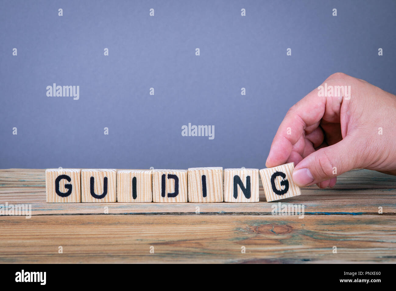guiding. Wooden letters on the office desk Stock Photo - Alamy