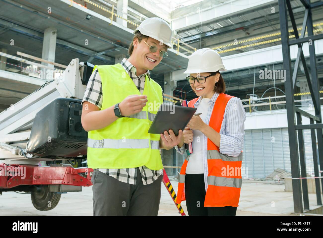 Woman architect and man builder at a construction site. Building ...