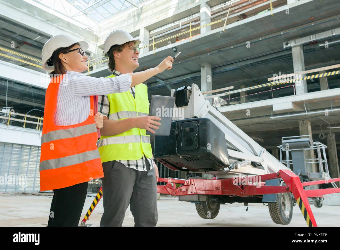 Woman architect and man builder at a construction site. Building ...