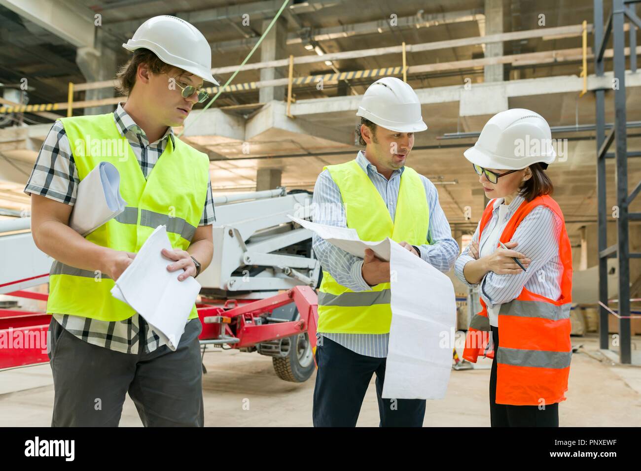 Group of engineers, builders, architects on the building site ...