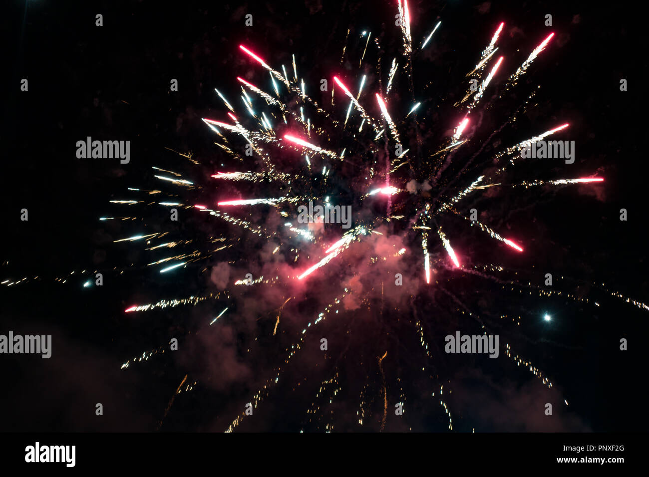 exploding fireworks in night sky Stock Photo - Alamy