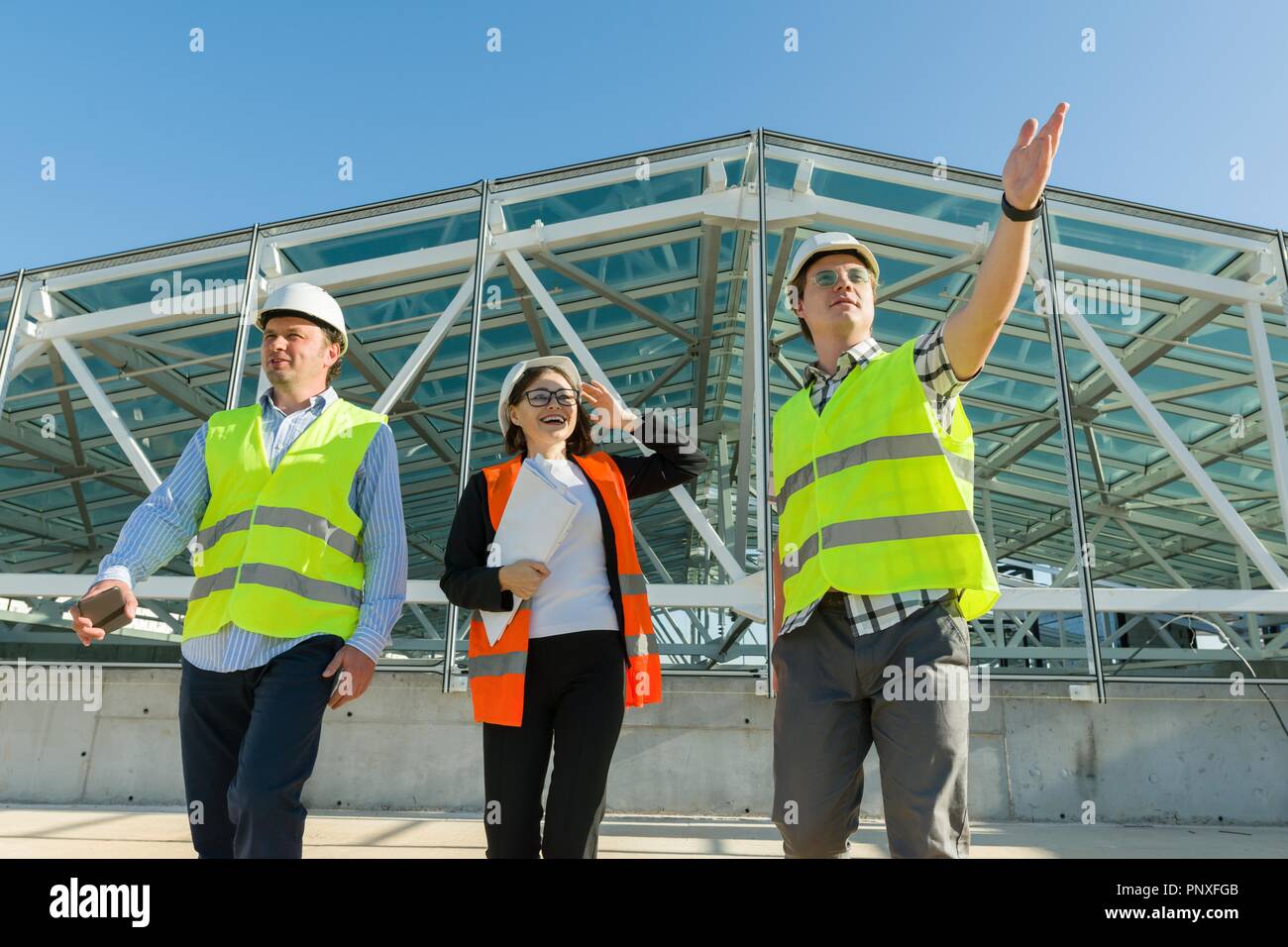 Group of engineers, builders, architects on the building site ...