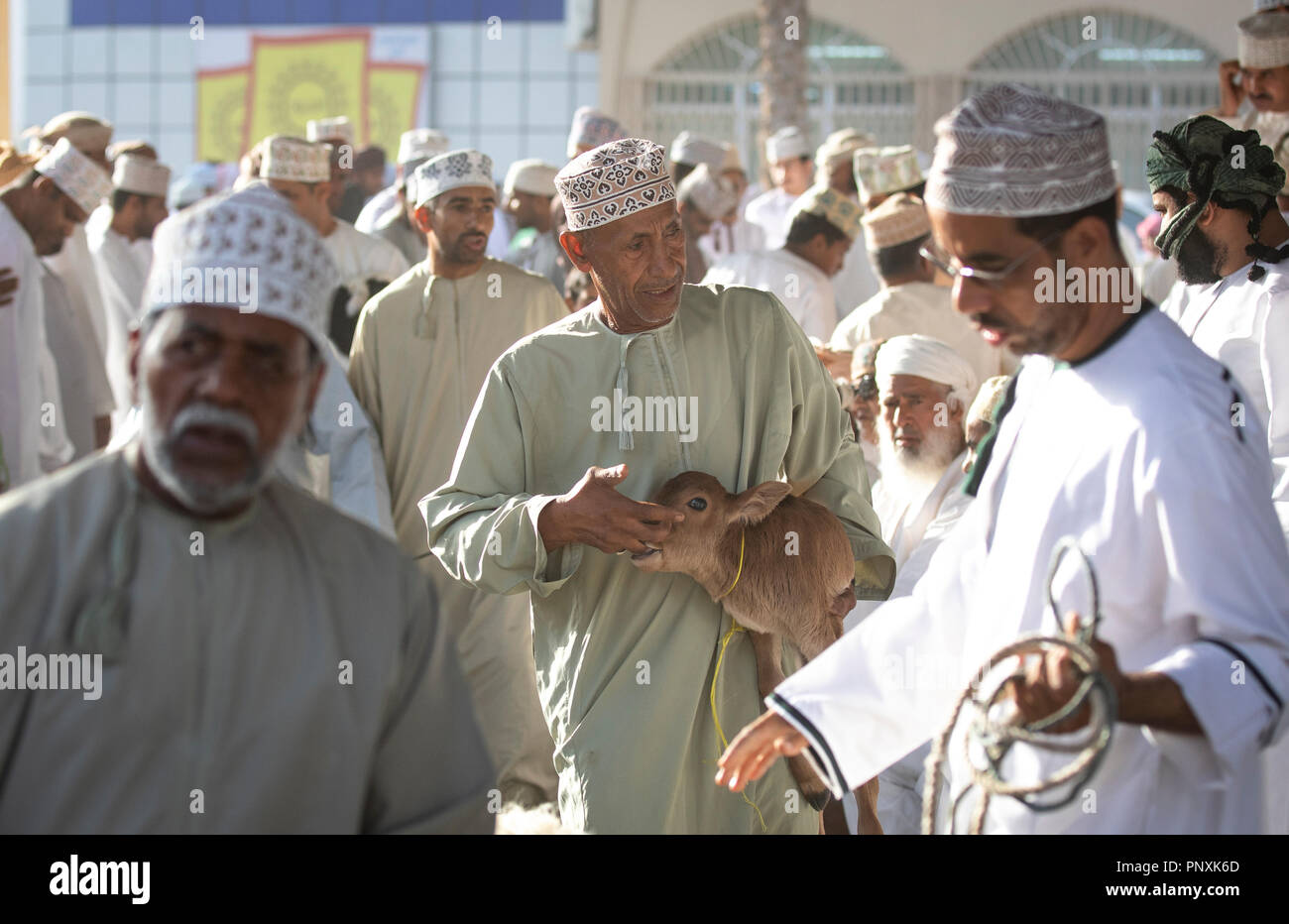 Nizwa, Oman, 21 September 2018: omani men at a market, buying and ...