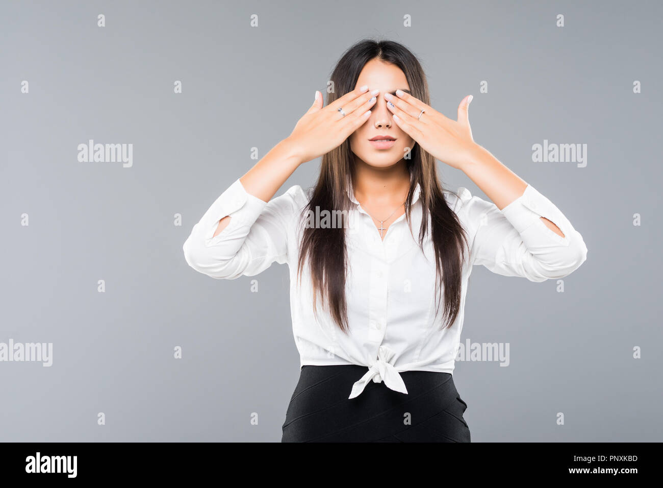 Beautiful woman covering her eyes with her hands Stock Photo - Alamy