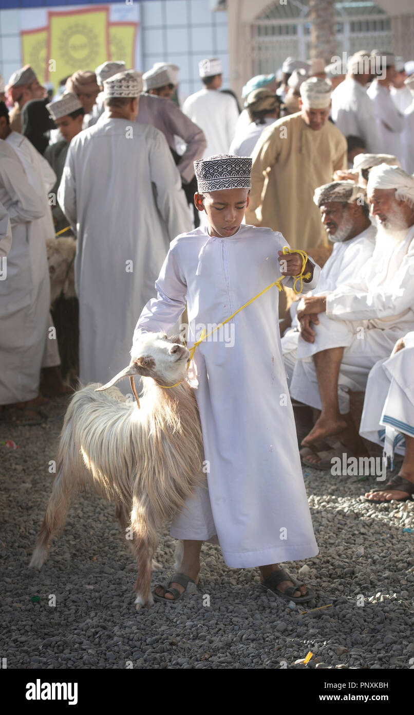 Nizwa, Oman, 21 September 2018: omani men at a market, buying and ...