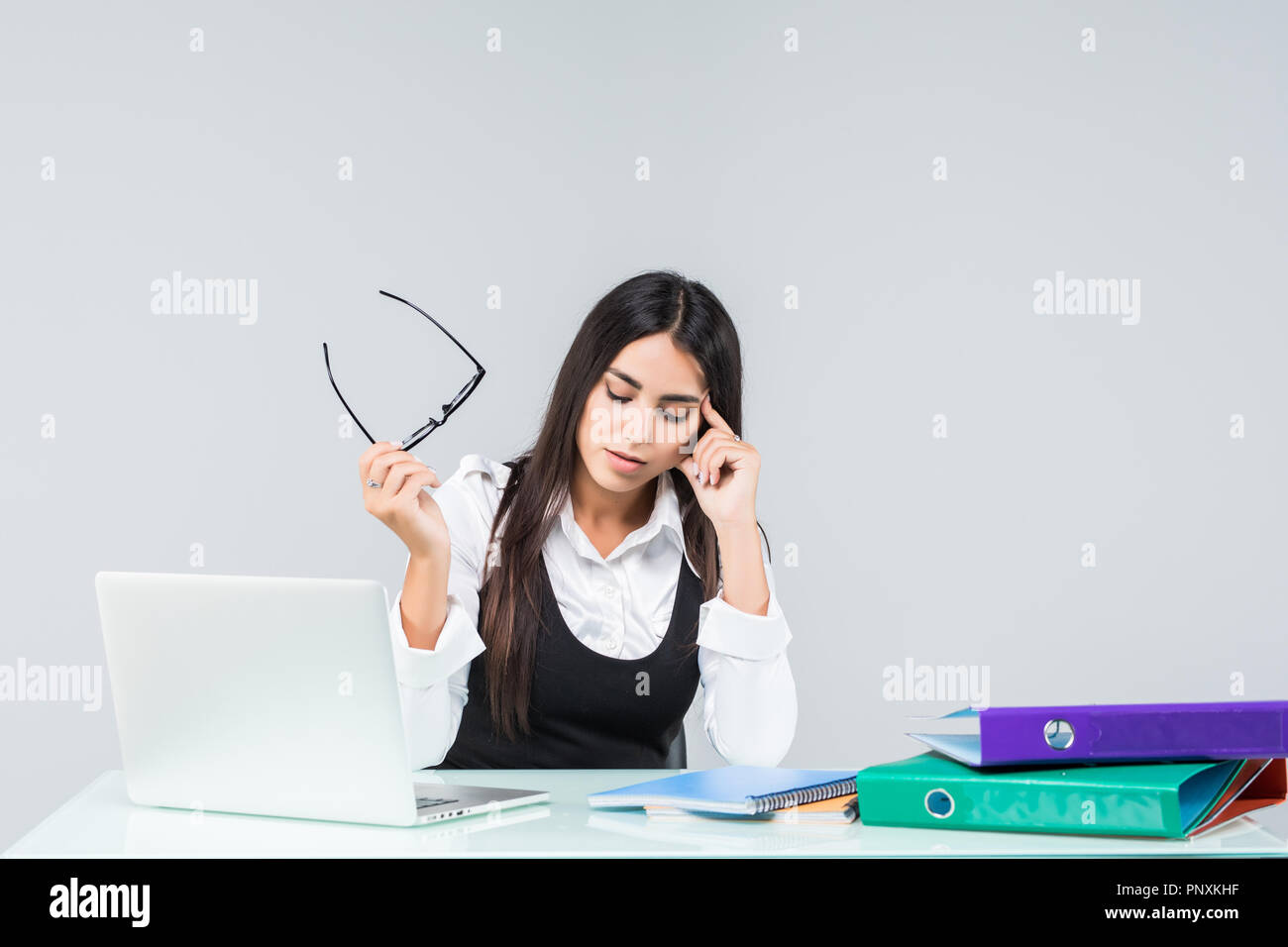 young attractive tired, overworked and exhausted female office worker ...