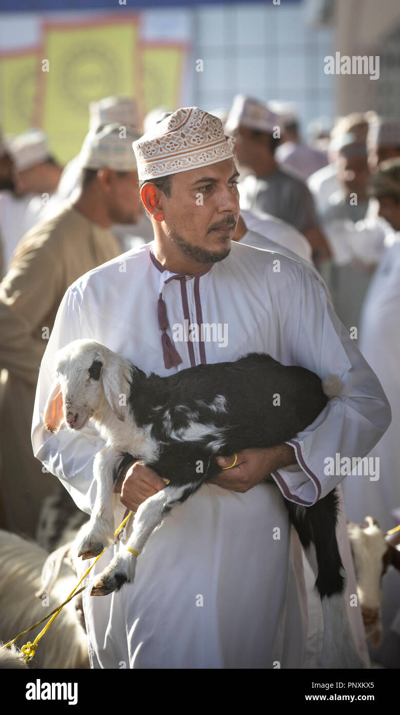 Nizwa, Oman, 21 September 2018: omani men at a market, buying and ...