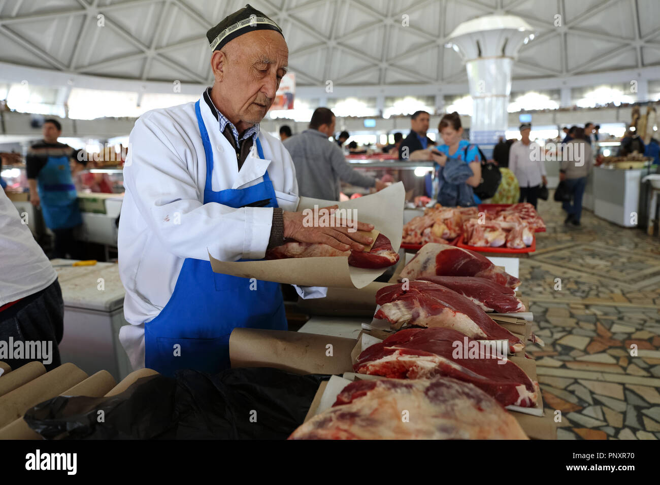 Tashkent, Uzbekistan - May 01, 2017: Unknown old Uzbek man packing ...