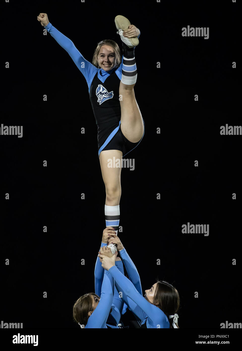 High school cheerleaders performing at a football game in Red Bluff ...