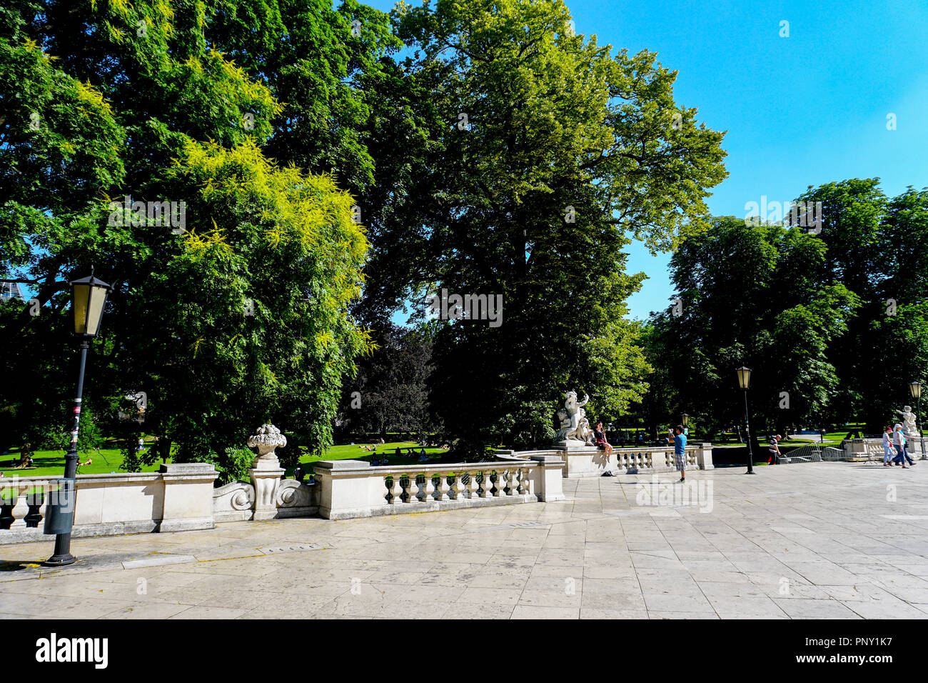 Sunny day in Vienna park with lanterns and concrete banister Stock ...